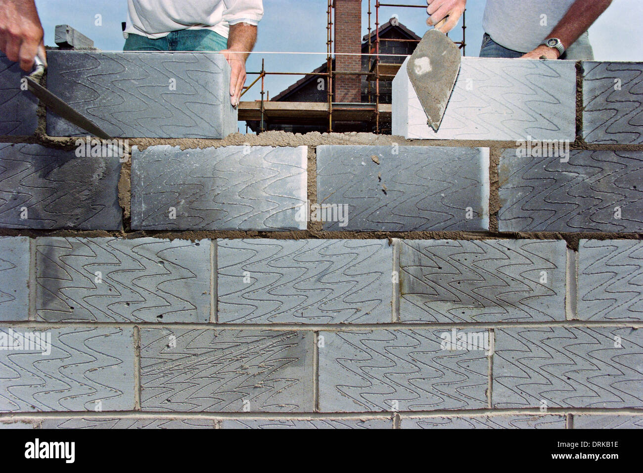 Bricklayers work on the construction of a new house Stock Photo - Alamy
