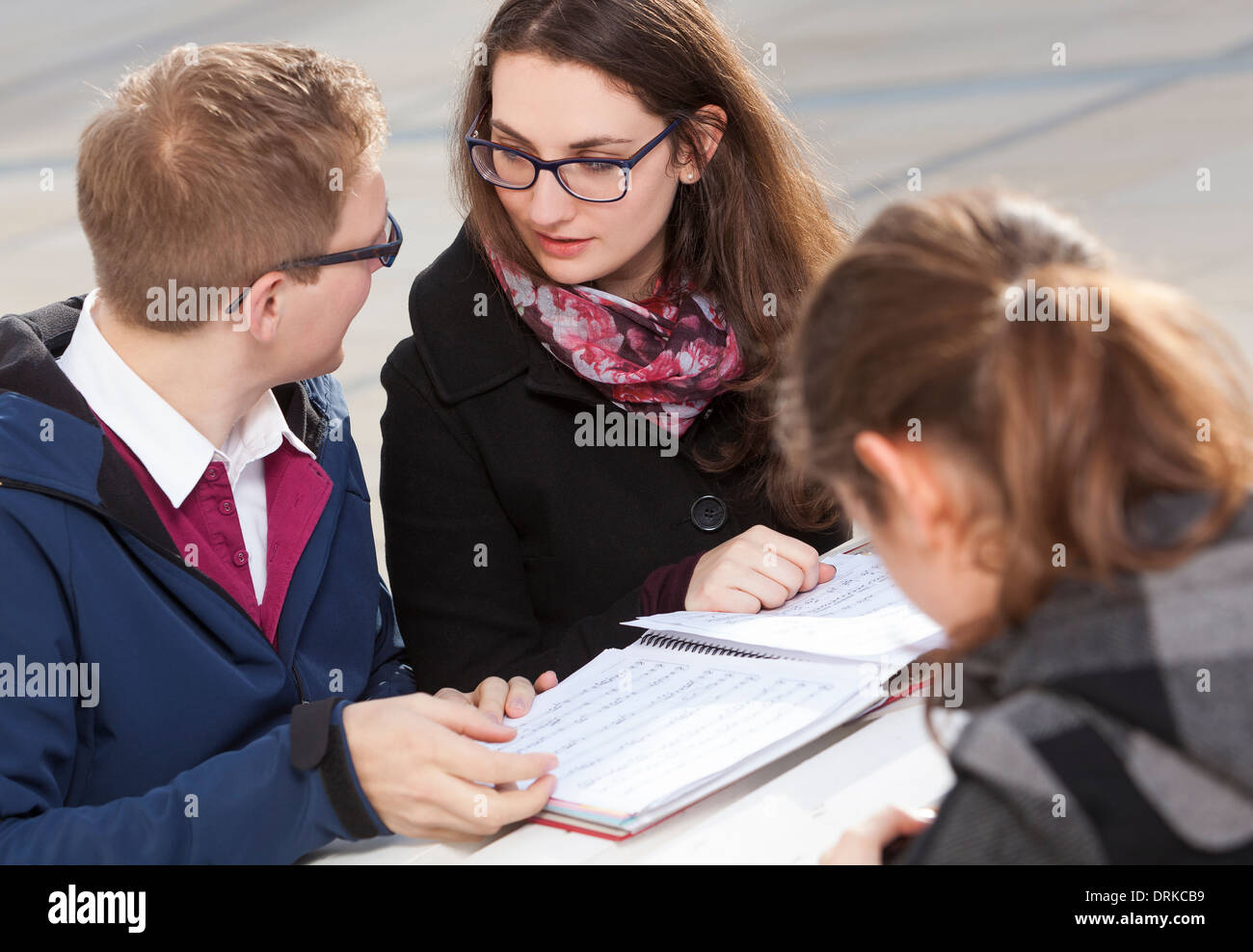 Three students learning together outdoors Stock Photo - Alamy