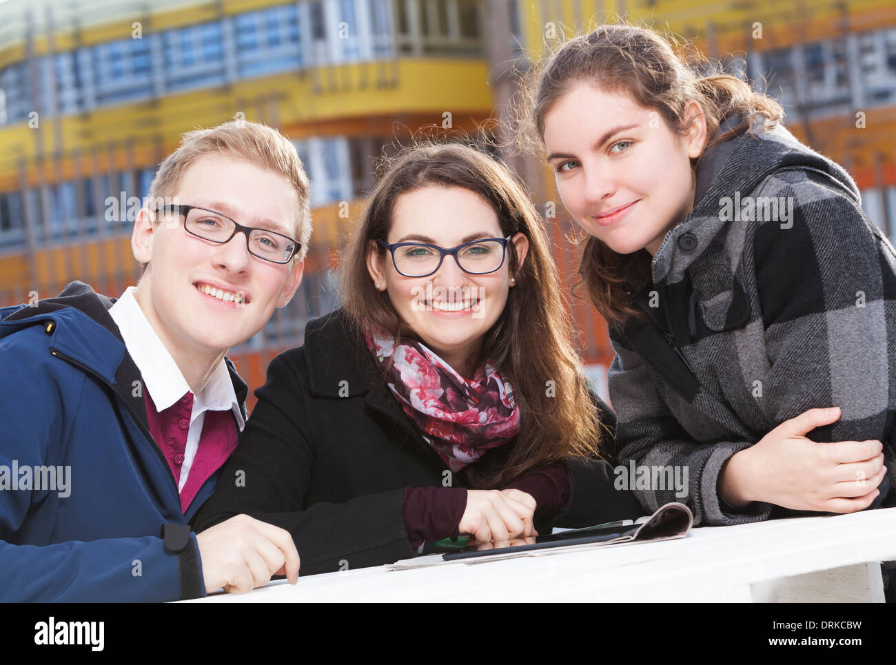 Three smiling students outdoors, portrait Stock Photo - Alamy