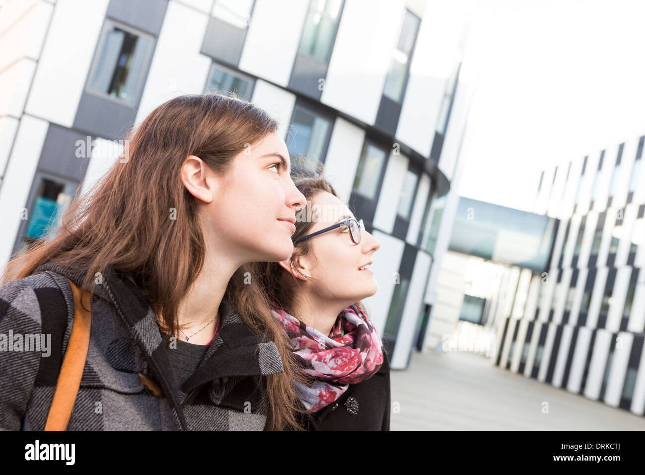 Two students outdoors looking up Stock Photo - Alamy