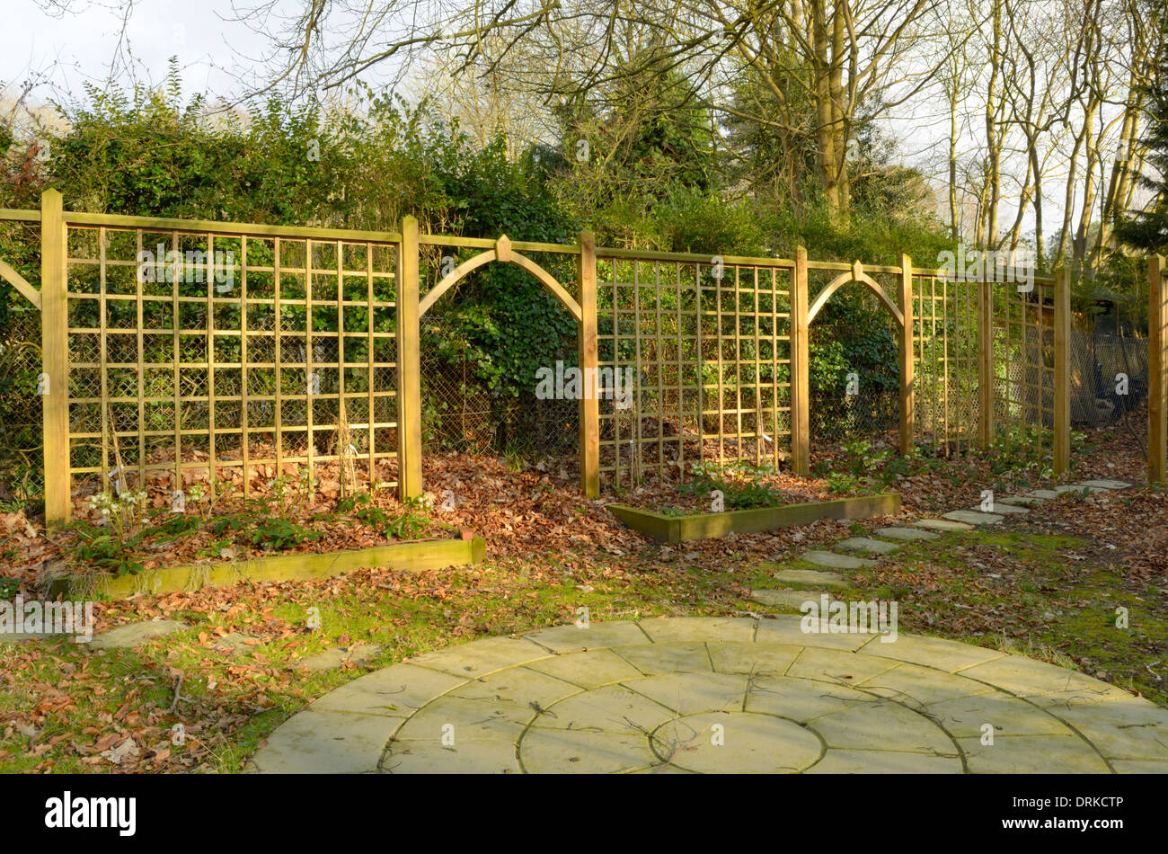 Woodland Garden with Trellis and Hellebores in dappled sun Stock Photo ...