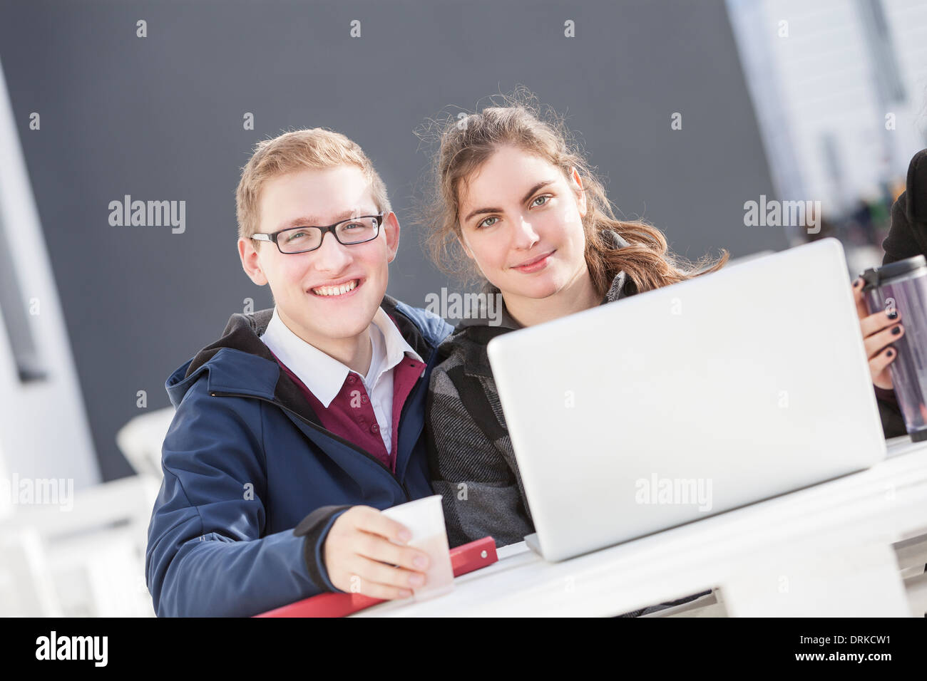 Two smiling students with laptop outdoors hi-res stock photography and ...