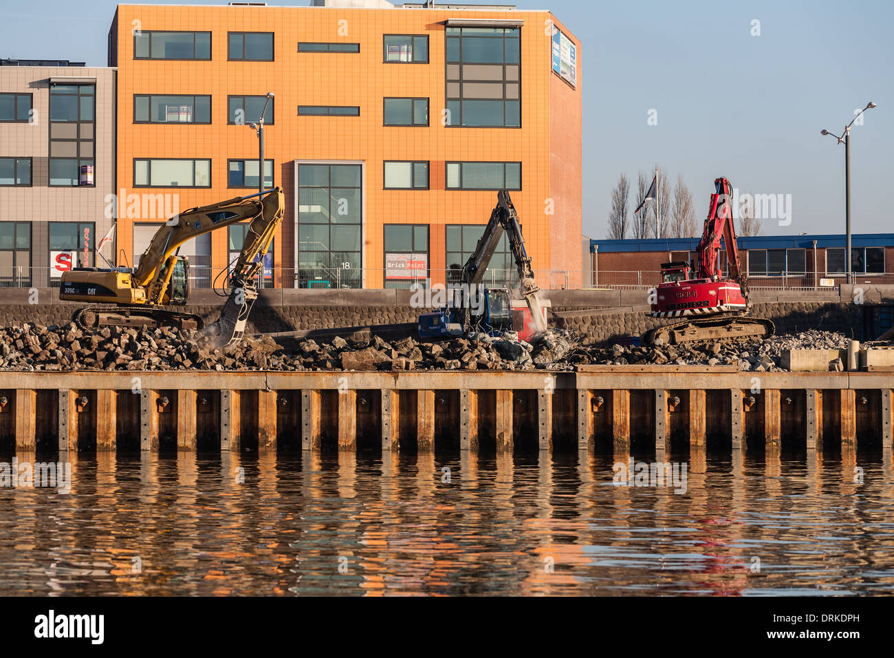 excavator crushing concrete piles Stock Photo - Alamy
