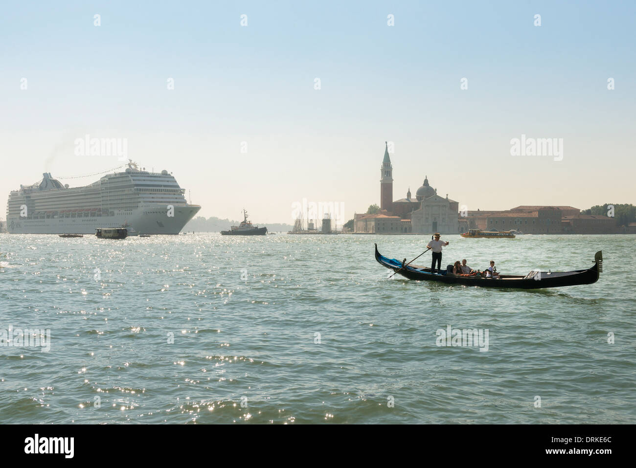 Cruise ship, gondola. Old and new transportation in the Venice lagoon ...