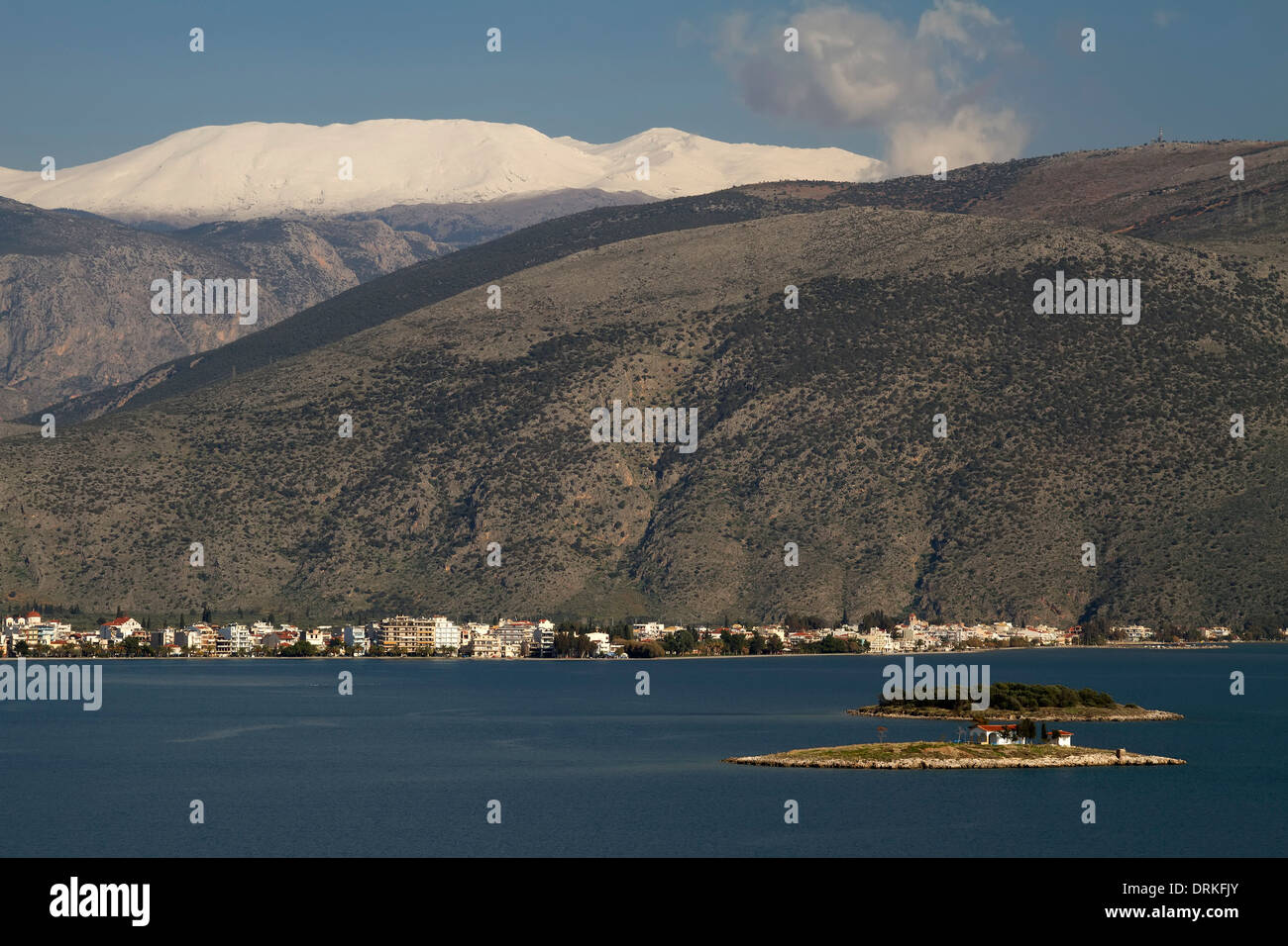 The port town of Itea, central Greece, with the snow-capped mountain of ...