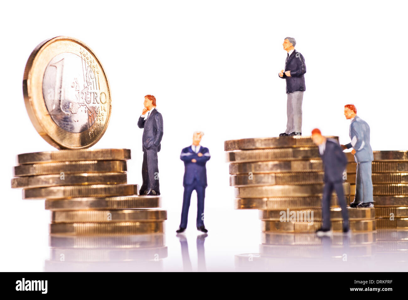 Model figures of business people with euro coins Stock Photo - Alamy