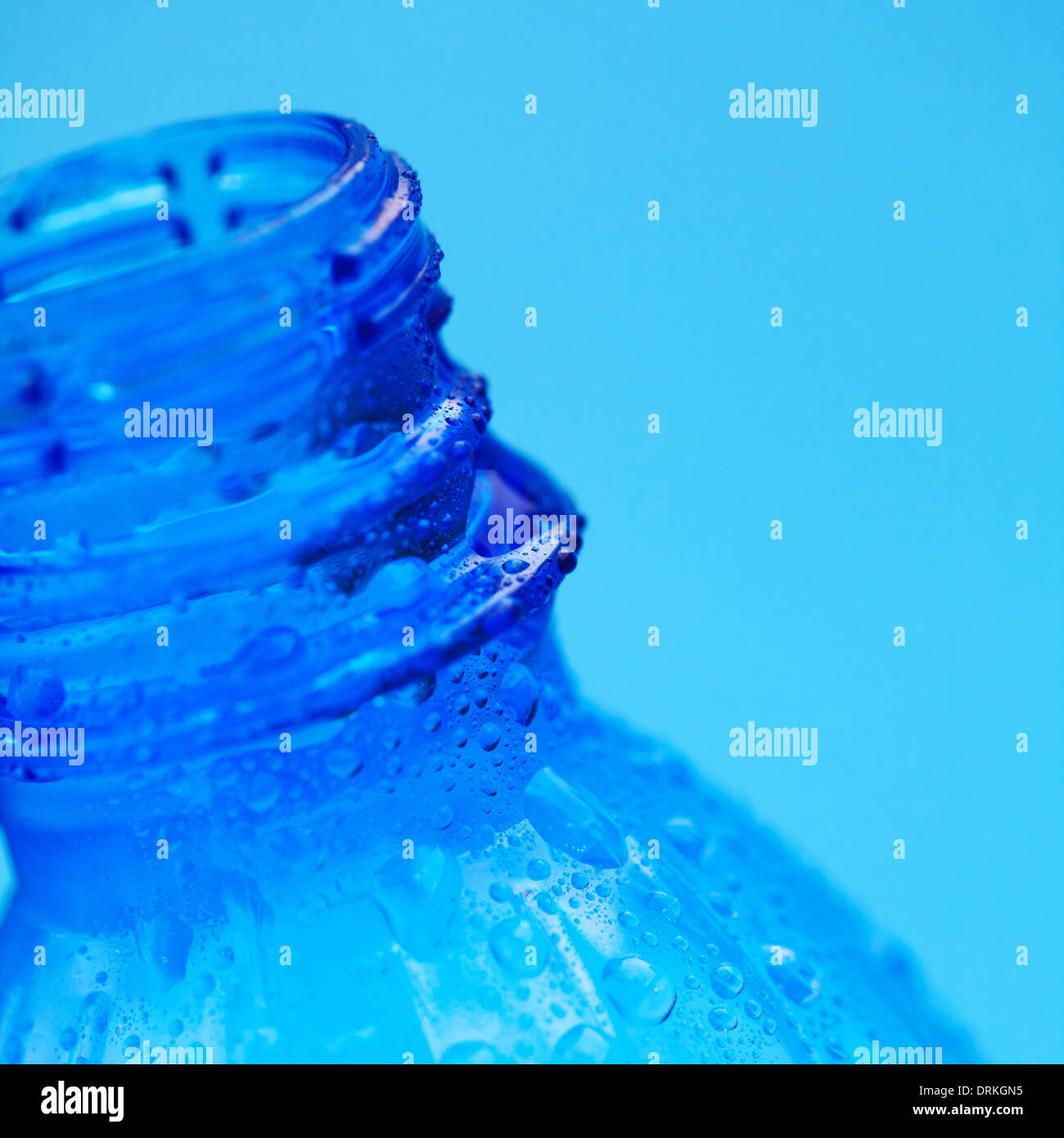 bottleneck with cold mineral water over blue. Selecrive focus Stock ...
