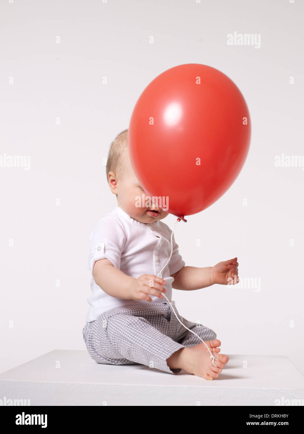 Baby holding balloon hi-res stock photography and images - Alamy