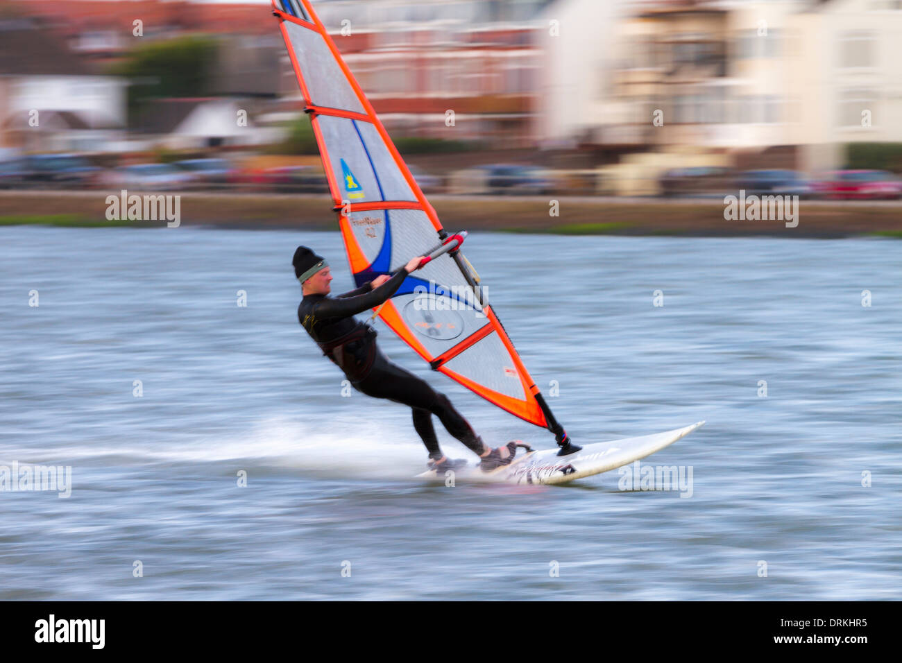 Male windsurfer sails on marine lake Stock Photo - Alamy