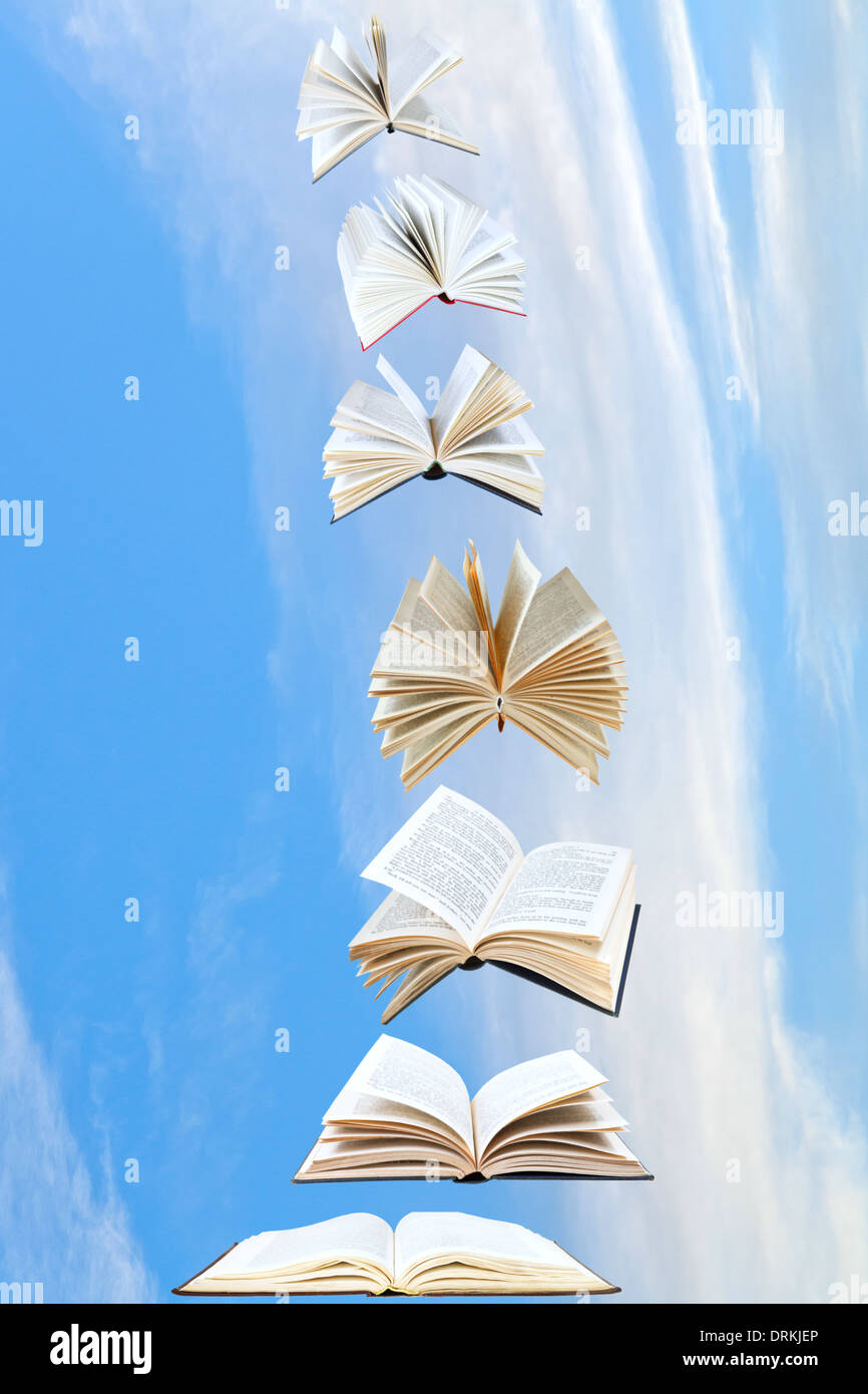 stack of books fly in blue sky with white cloud Stock Photo - Alamy