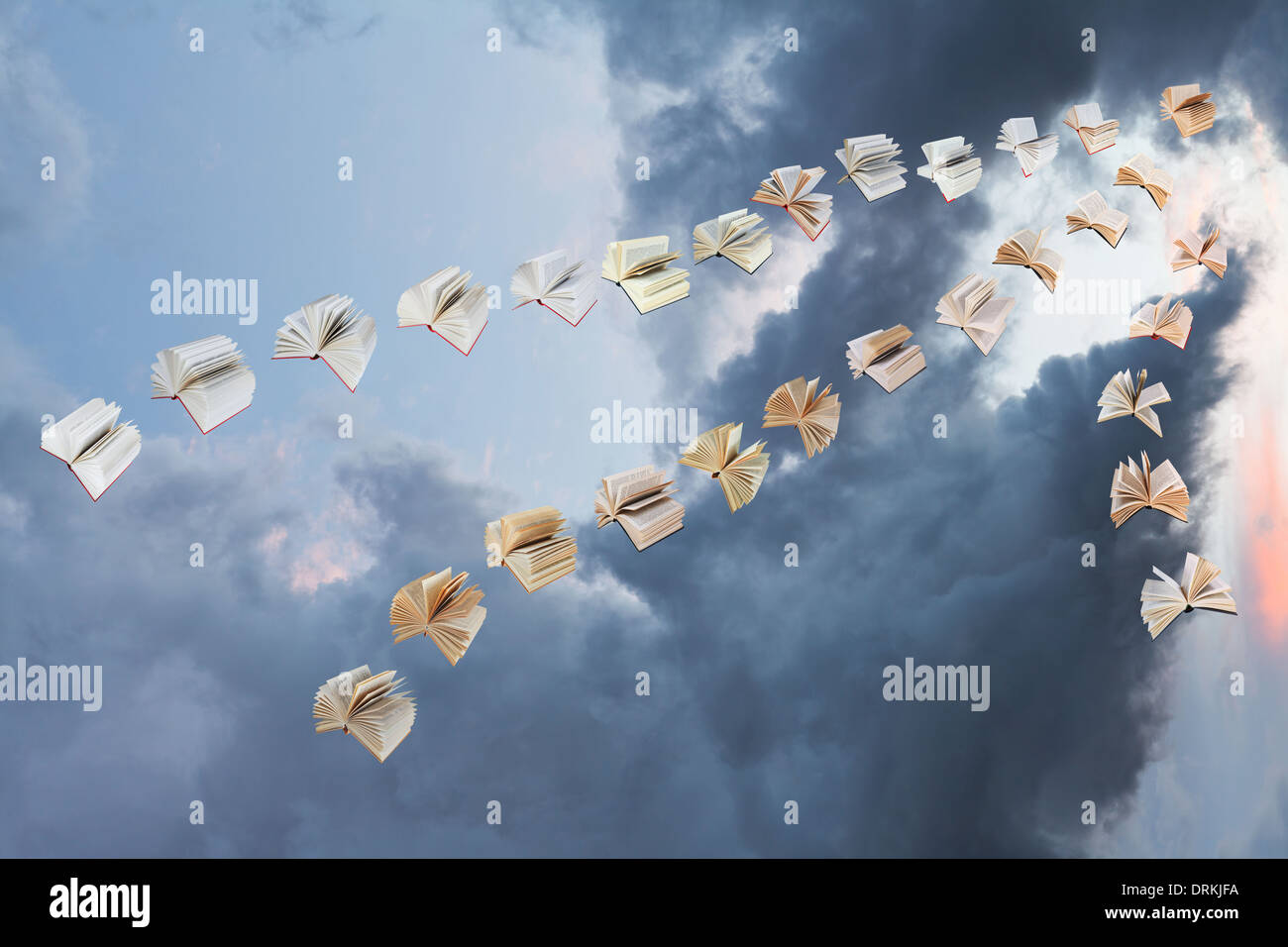flock of flying books with storm clouds background Stock Photo - Alamy