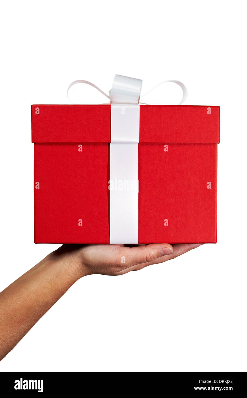 Hand holding christmas present Stock Photo - Alamy