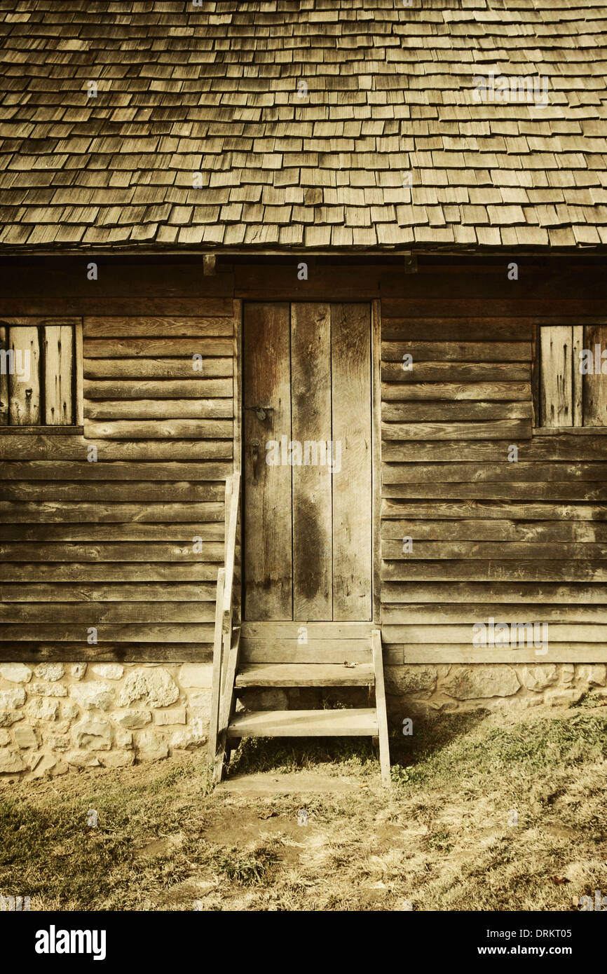 A minimalistic view of an old clapboard dwelling with a wooden shingle ...