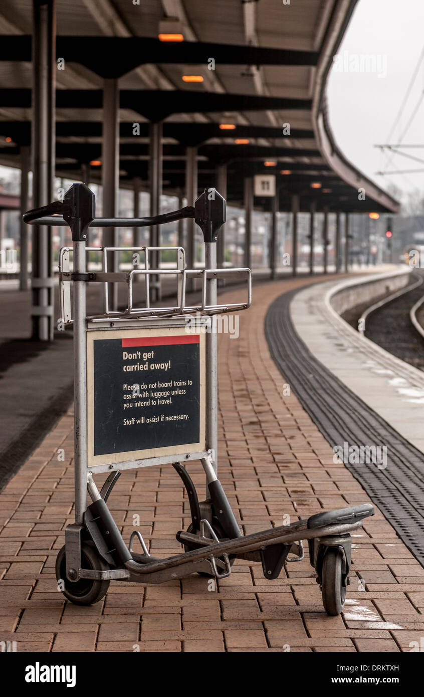 Empty railway platform with luggage trolley Stock Photo - Alamy