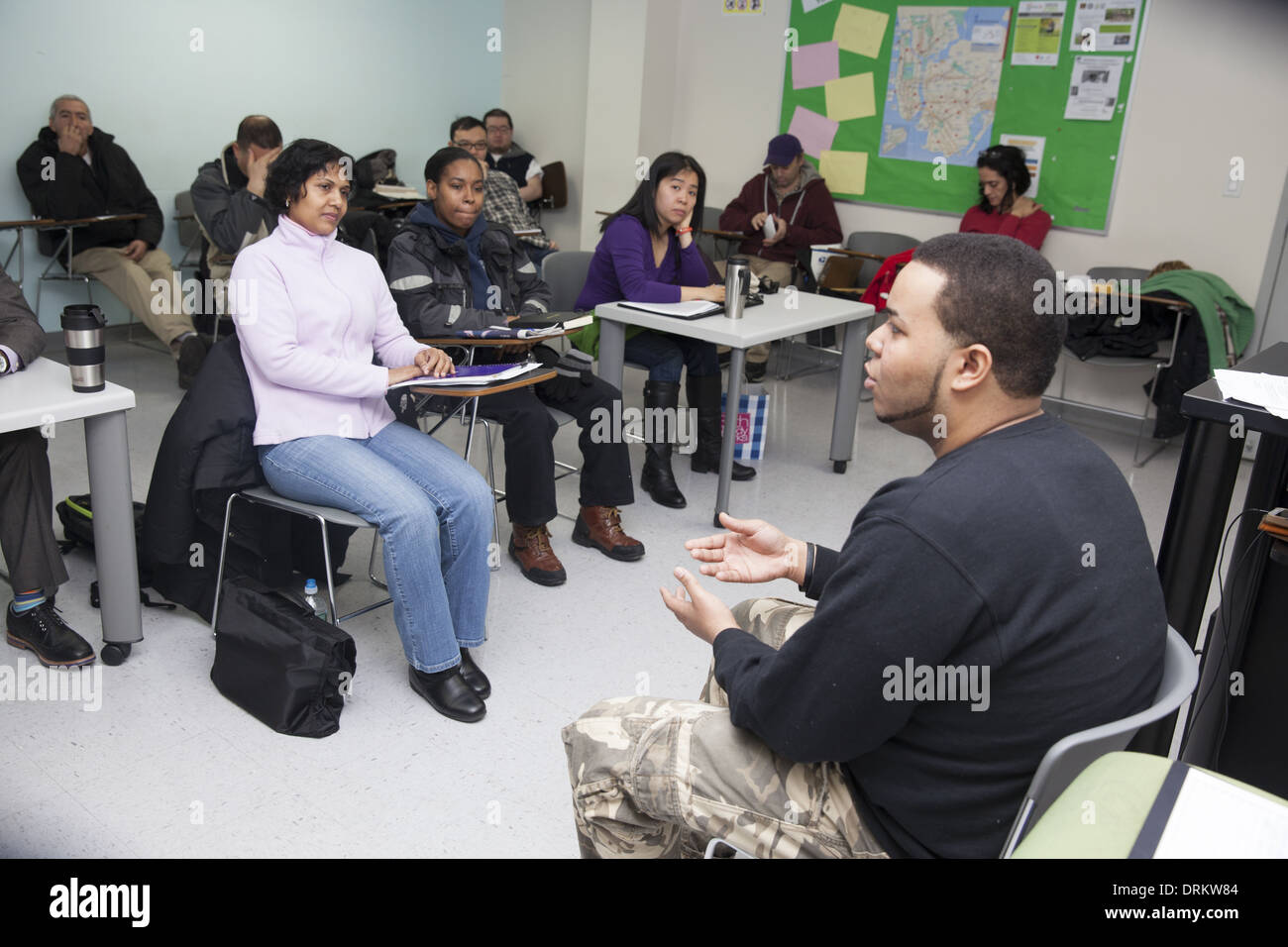 Man role plays having an interview in a class to help people prepare ...