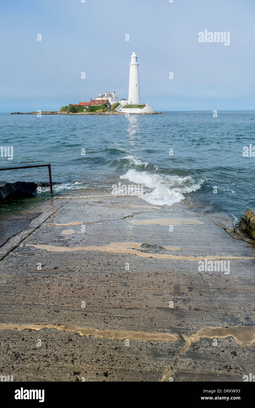 Submerged causeway leading to St Mary's Island and lighthouse at high ...