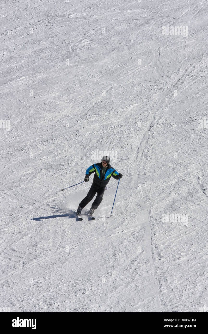 Lone skier going down the mountain Stock Photo - Alamy
