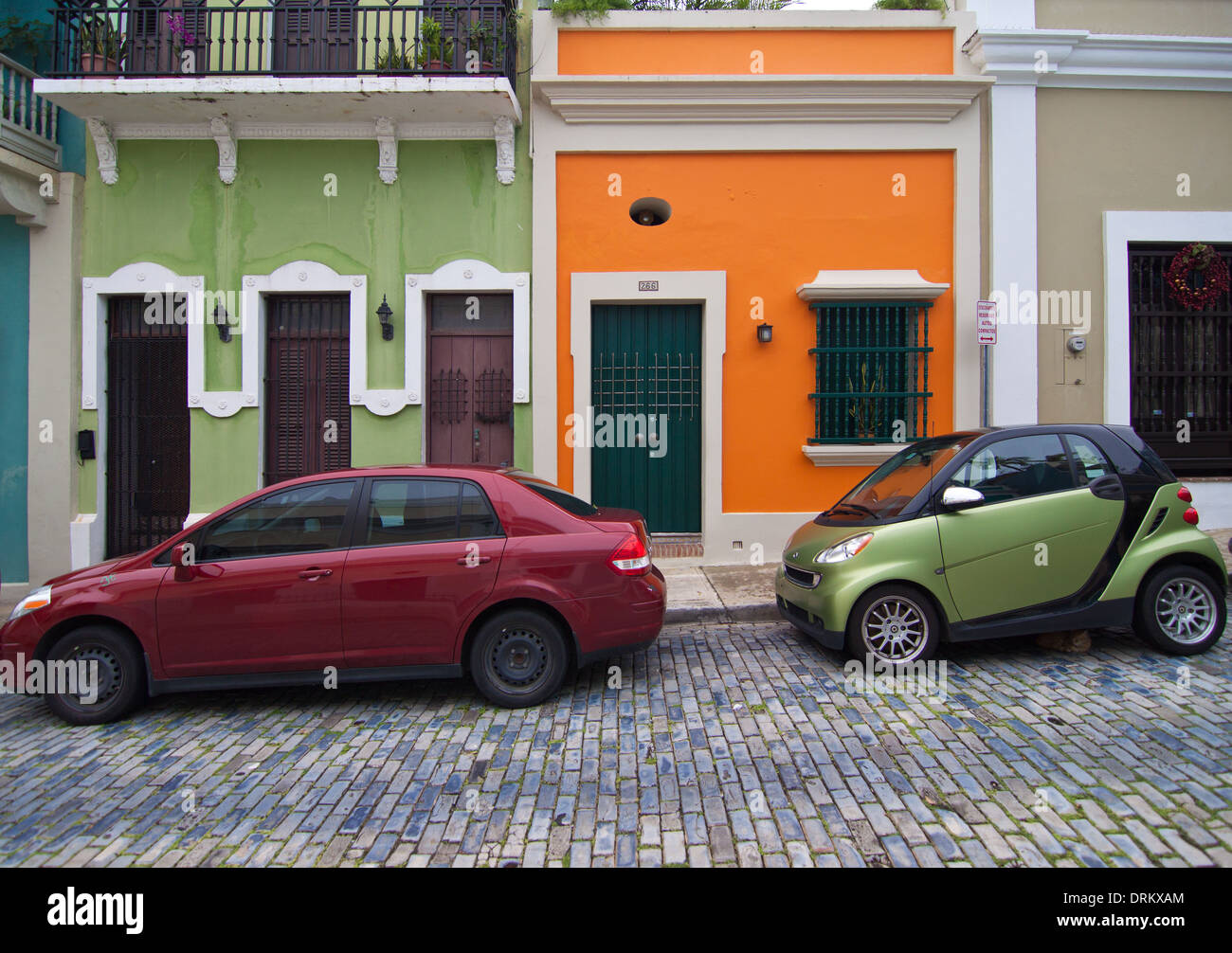 Colorful houses and cars on blue cobblestone street in Old San Juan ...