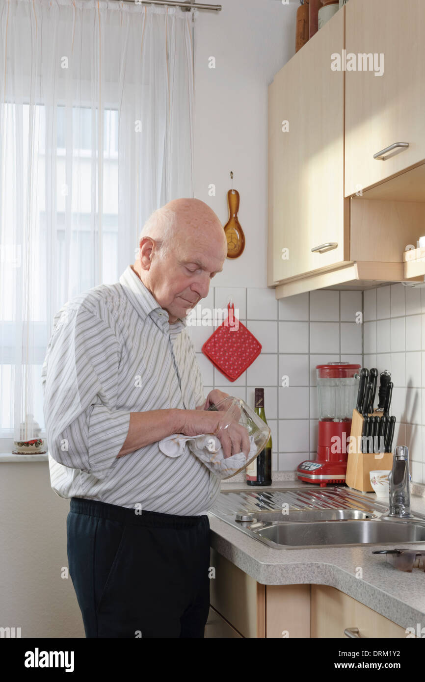 Old man making drying coffee pot Stock Photo - Alamy