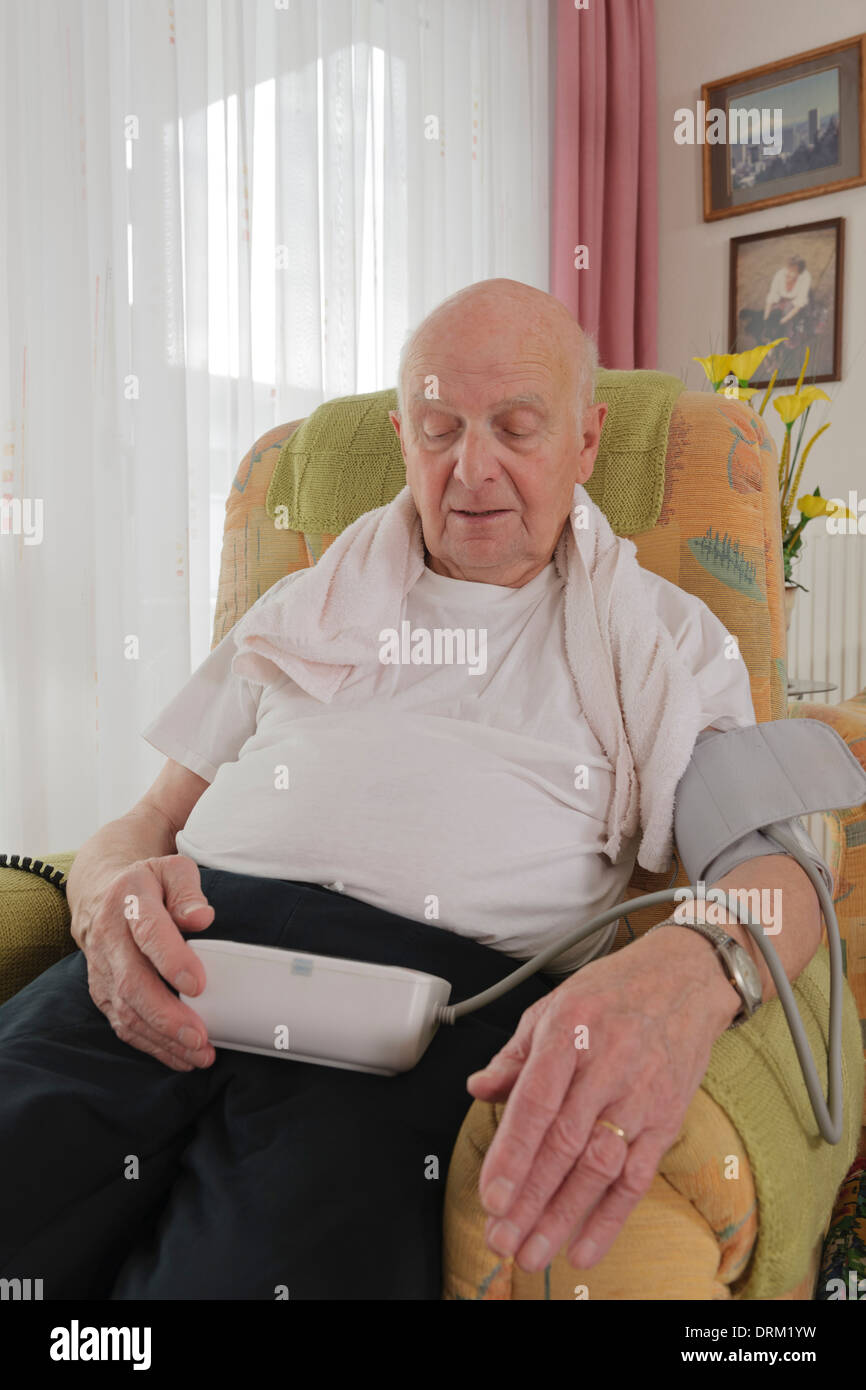 Old man checking his blood pressure Stock Photo - Alamy