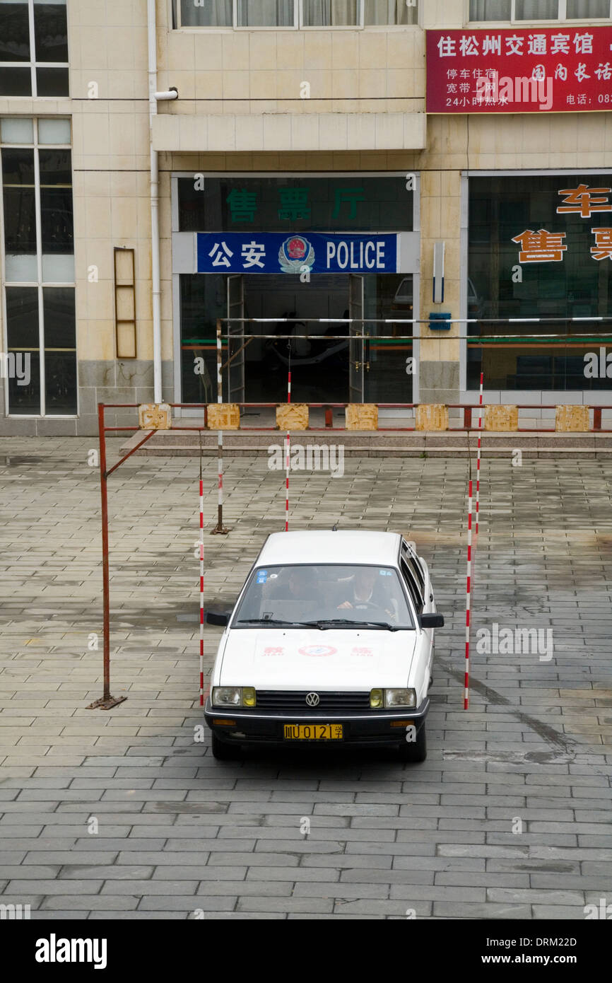 Learner driver practising manouvering / manoeuvres around hanging ...