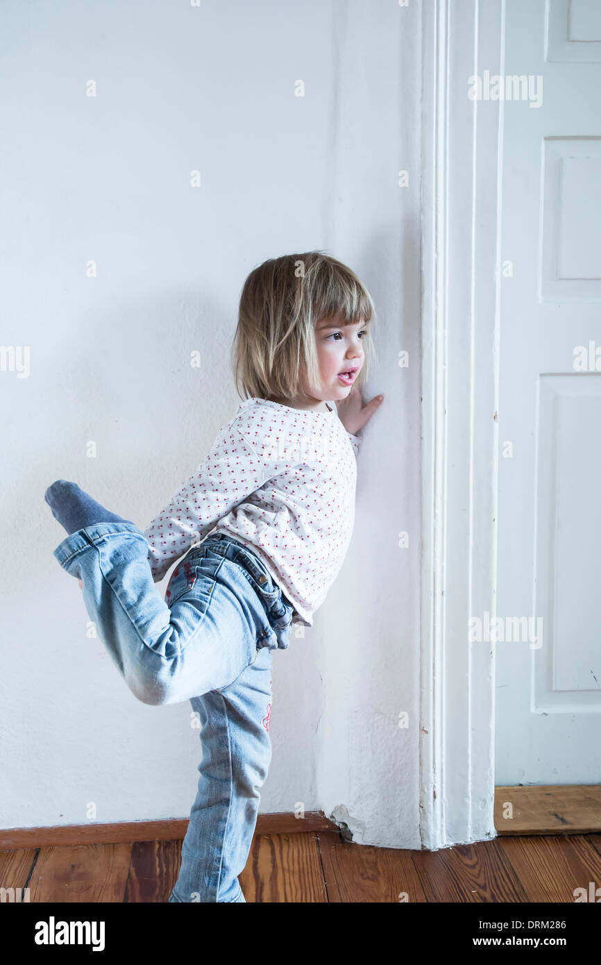 Little girl standing on one leg Stock Photo - Alamy