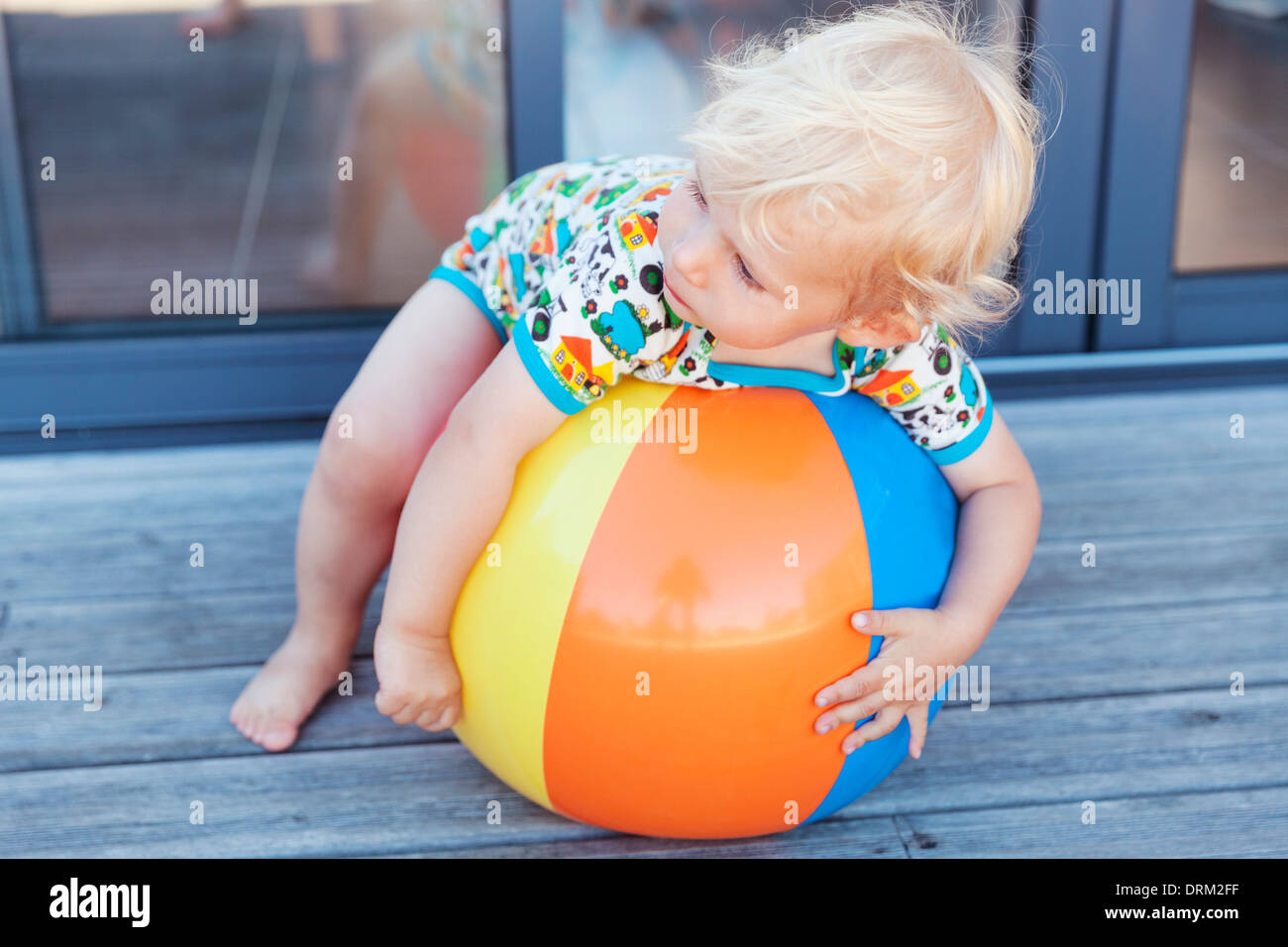 Little boy relaxing on beach ball Stock Photo - Alamy