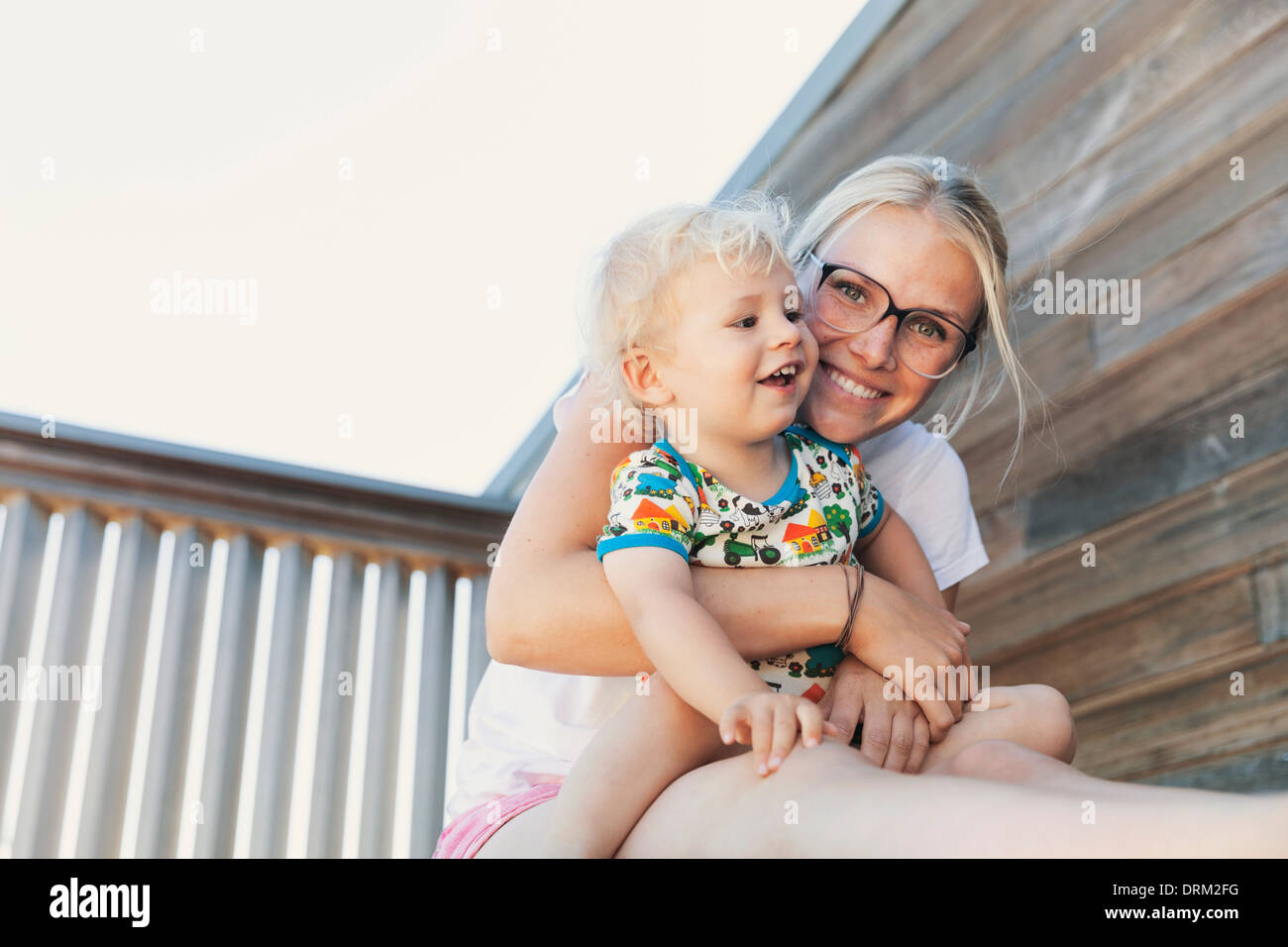 Little boy sitting on his mothers lap Stock Photo - Alamy