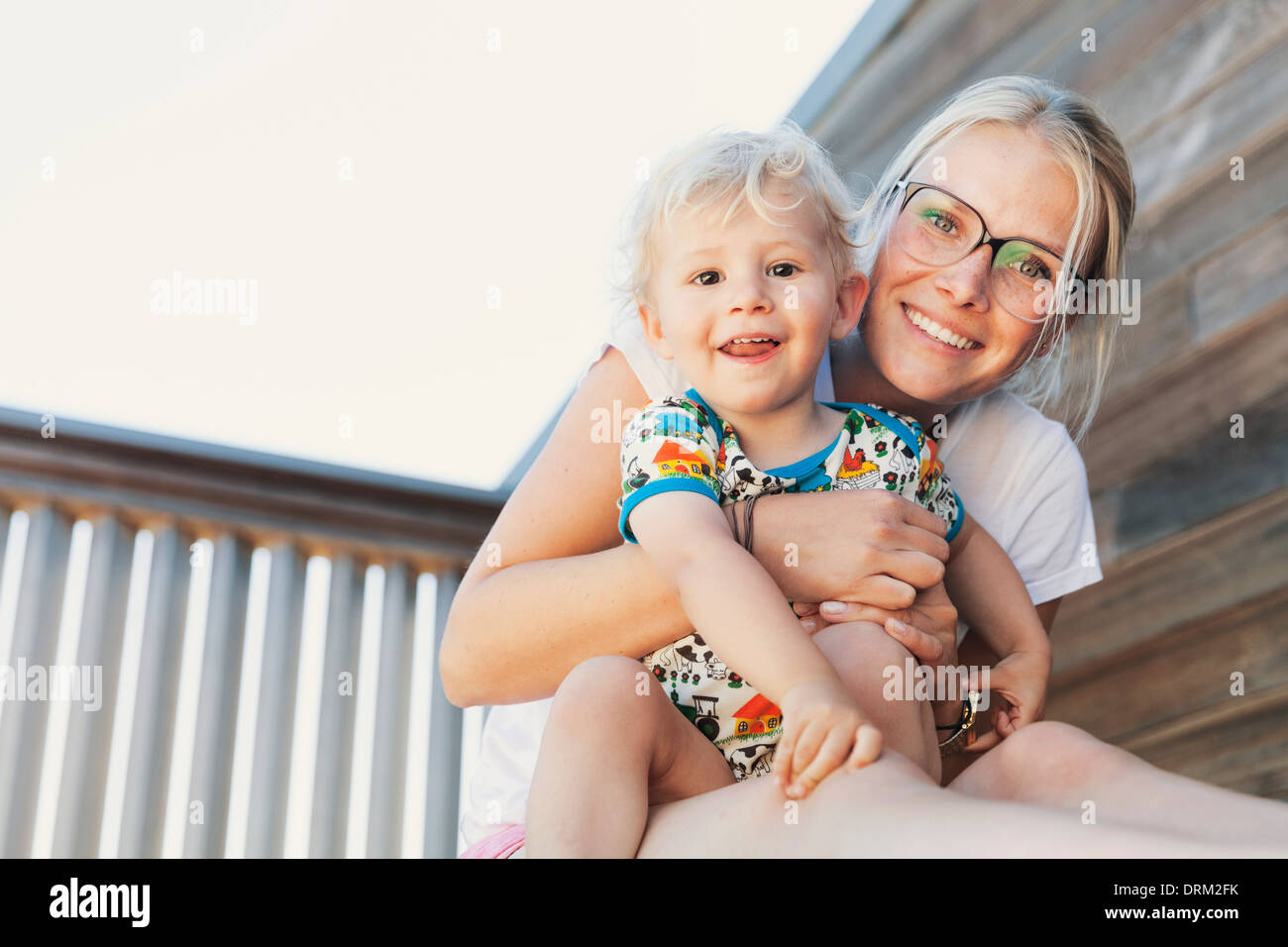 Boy embracing sitting on lap hi-res stock photography and images - Alamy