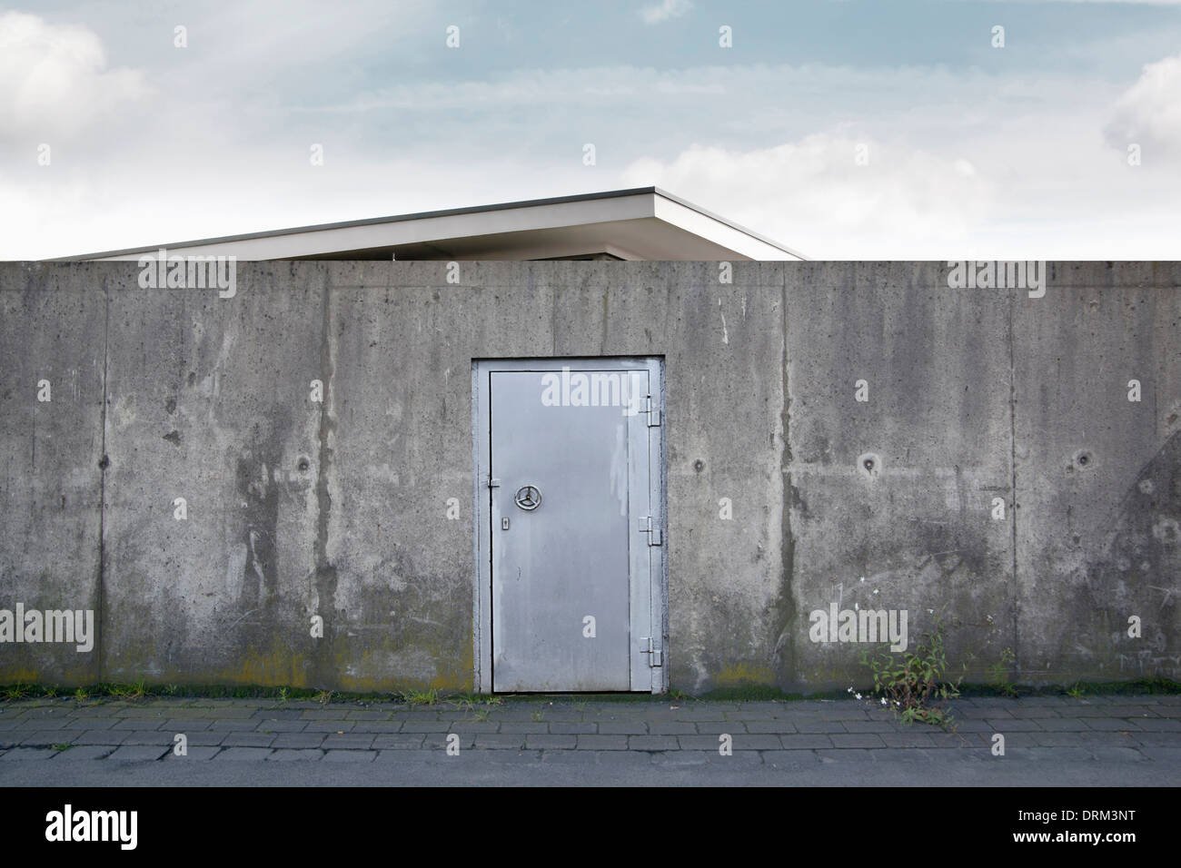 Building behind a wall with a safety door, composing Stock Photo - Alamy