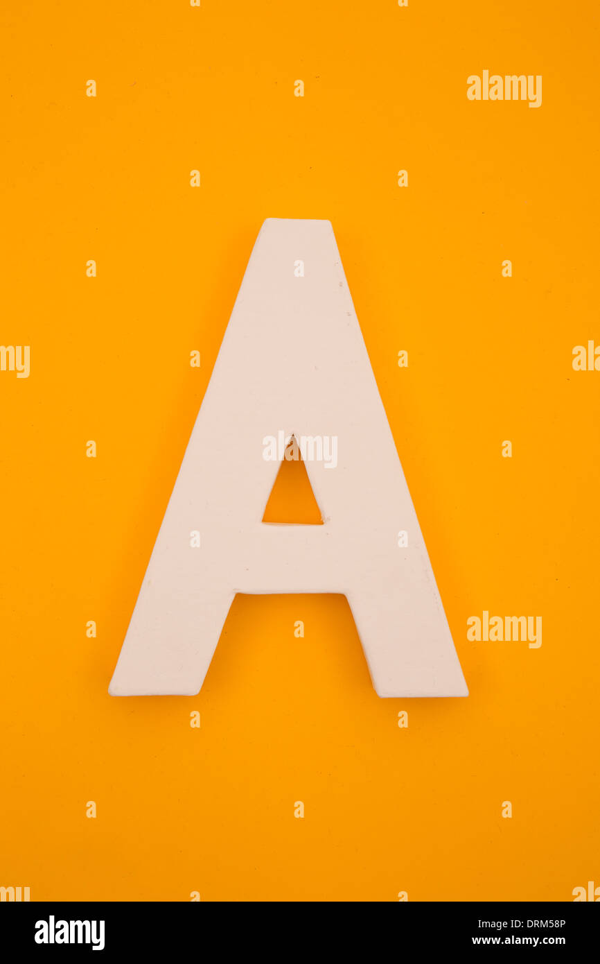 White letter "A" formed at yellow background, studio shot Stock Photo ...