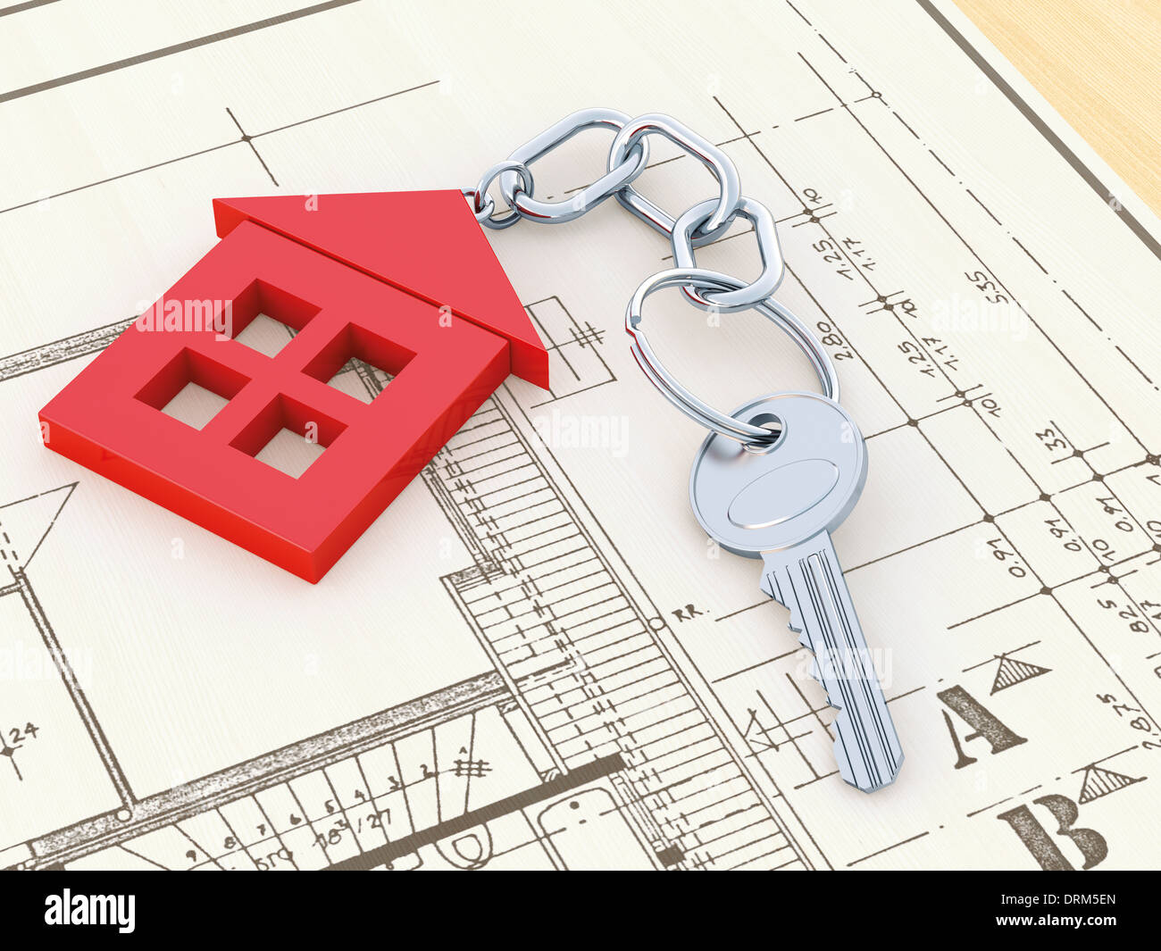 Key with red key chain formed like a house lying on construction plan ...