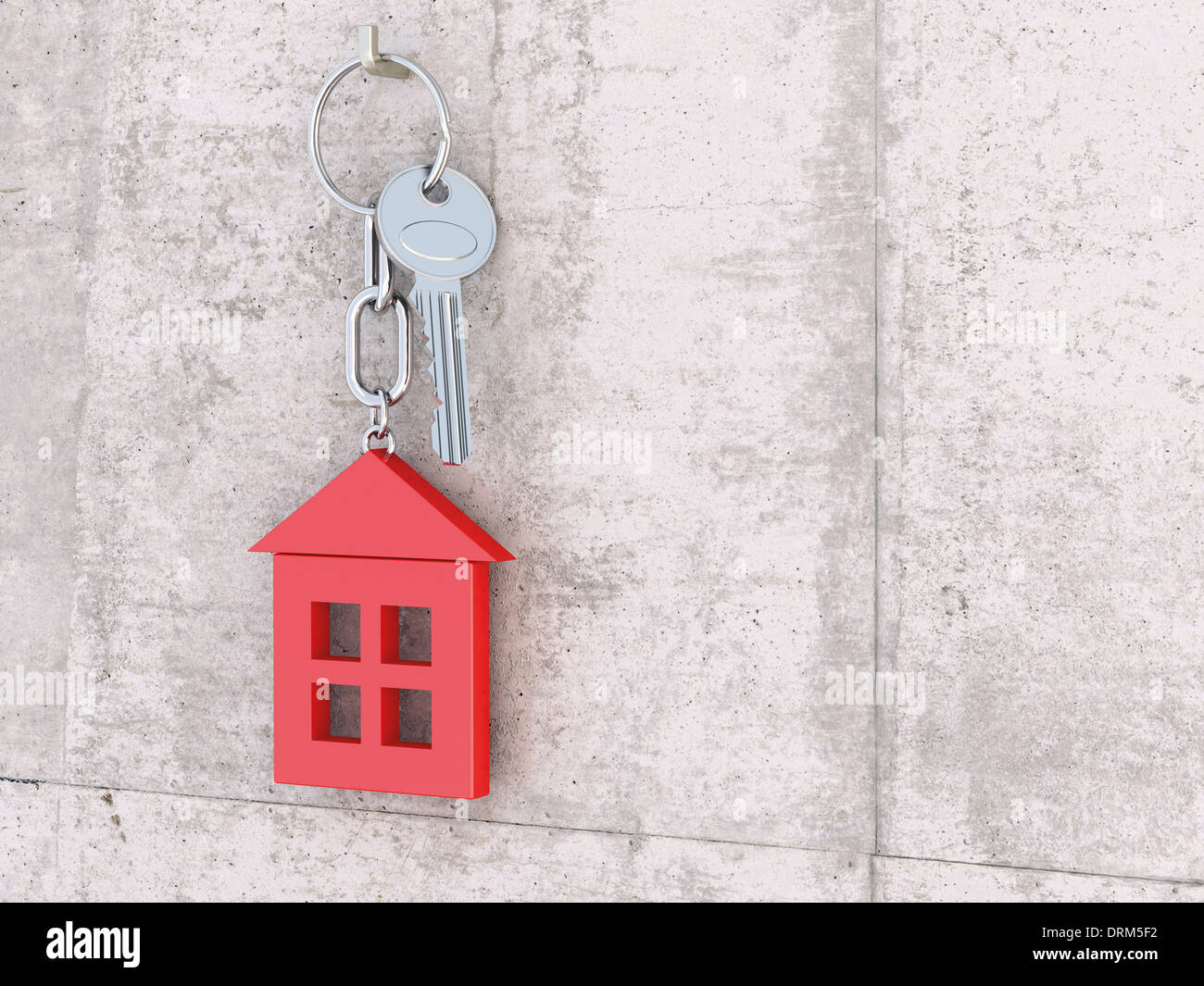 Key with red key chain formed like a house hanging at key hook fixed at ...