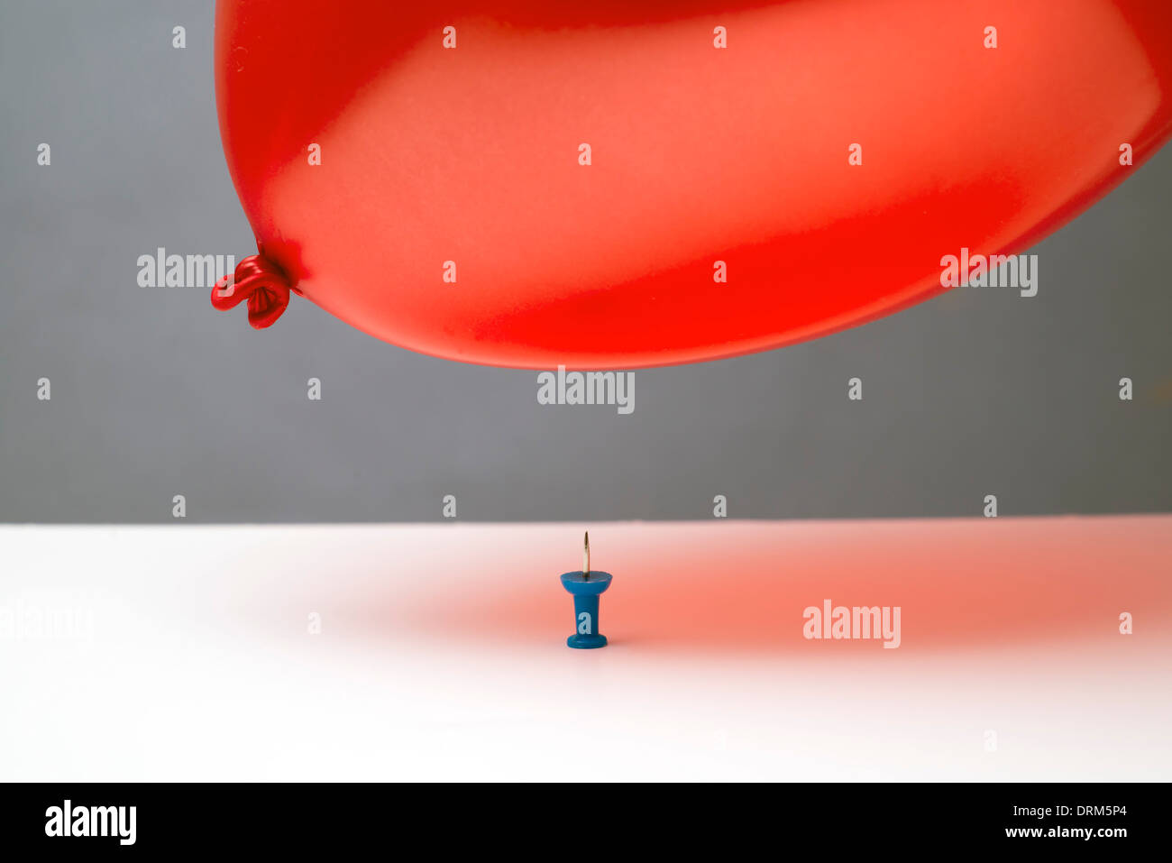 Balloon about to fall on pushing Stock Photo - Alamy