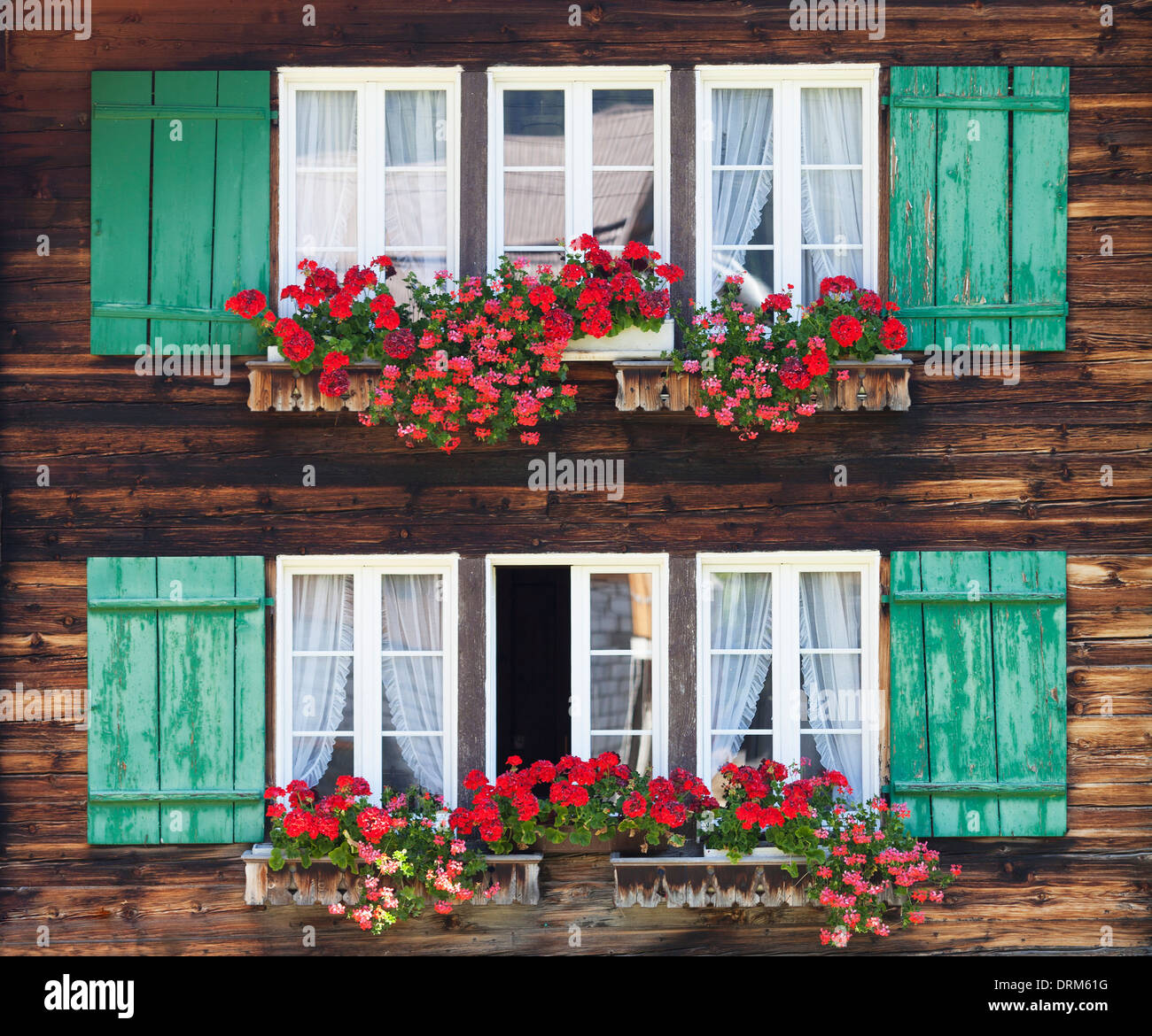Switzerland, Bernese Oberland, Windows with flower boxes of farmhouse ...