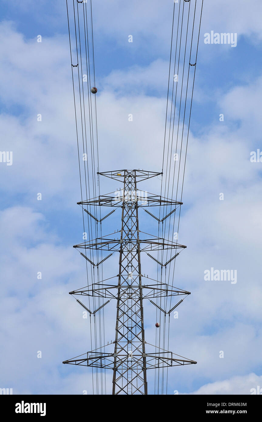Electrical tower in field under blue sky Stock Photo - Alamy