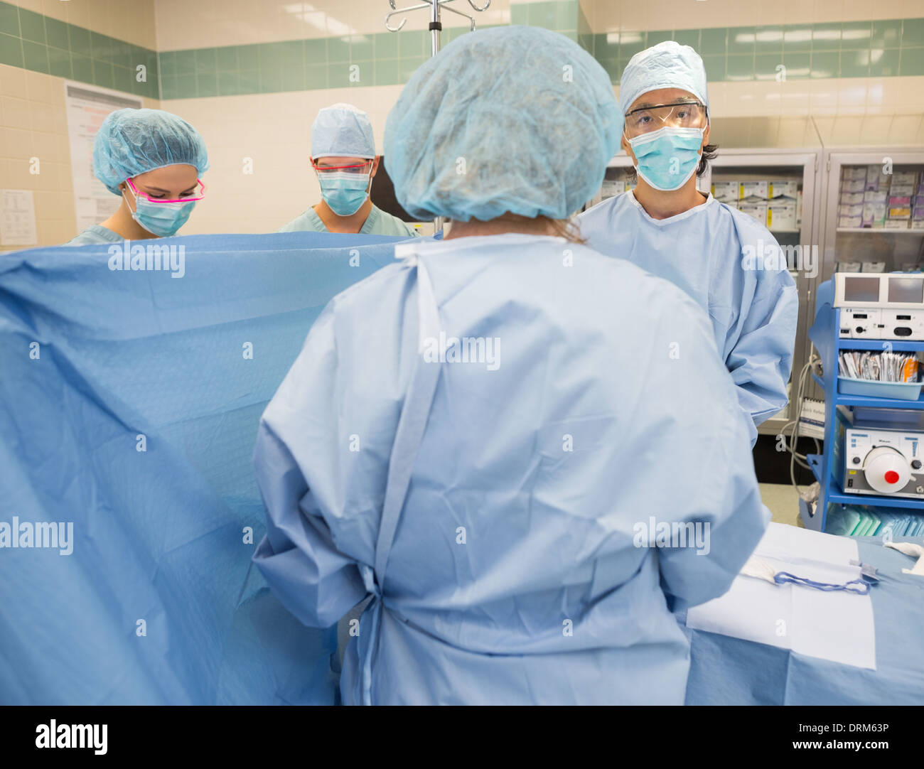 Doctor With Team Operating Patient Stock Photo - Alamy