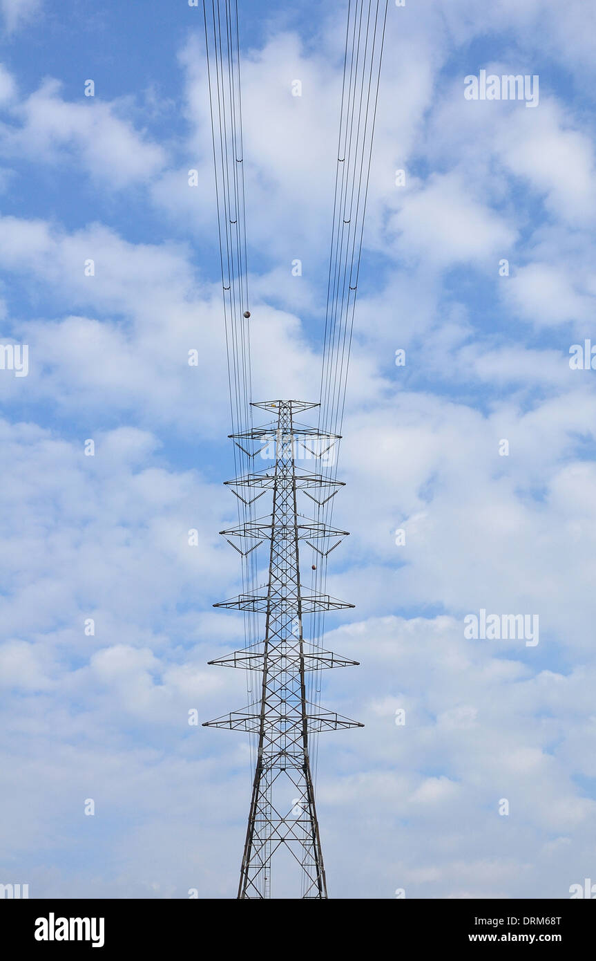 Electrical tower in field under blue sky Stock Photo - Alamy