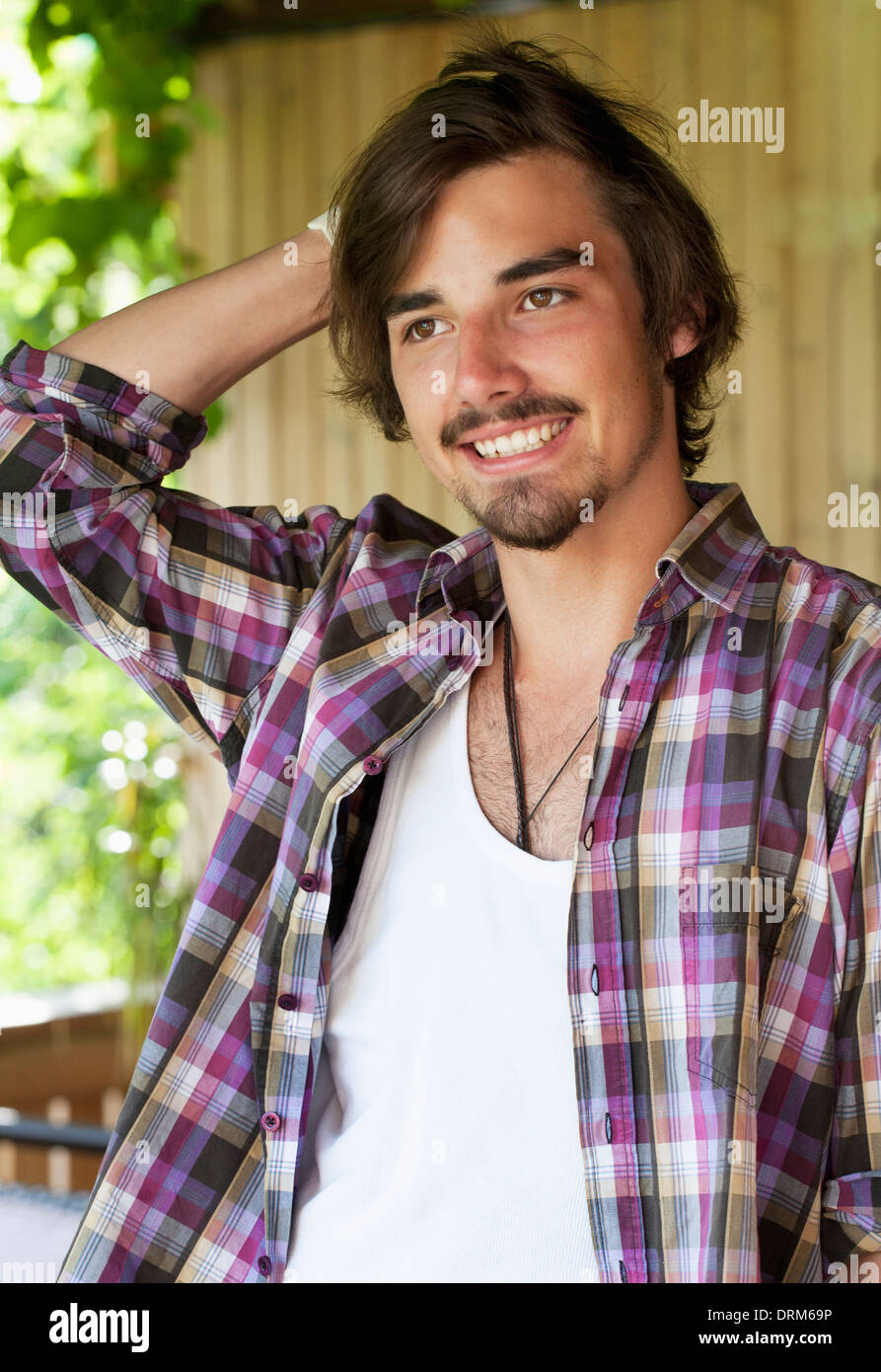 Portrait of unconfident young man Stock Photo - Alamy