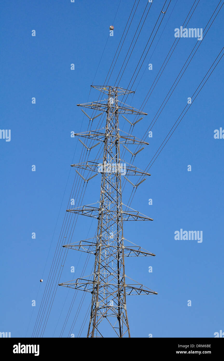 Electrical tower in field under blue sky Stock Photo - Alamy