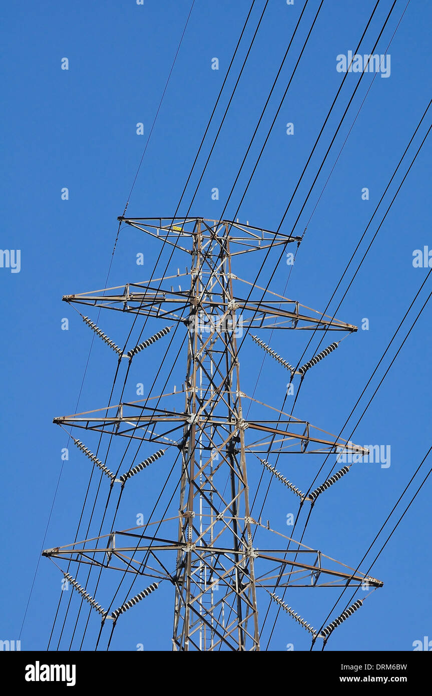 Electrical tower in field under blue sky Stock Photo - Alamy