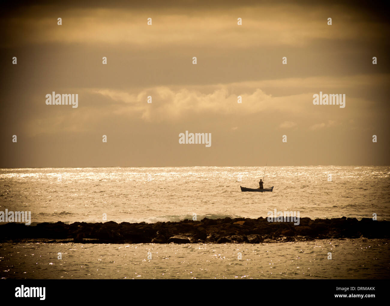 A Fisherman silhouette at sunset low key Stock Photo - Alamy