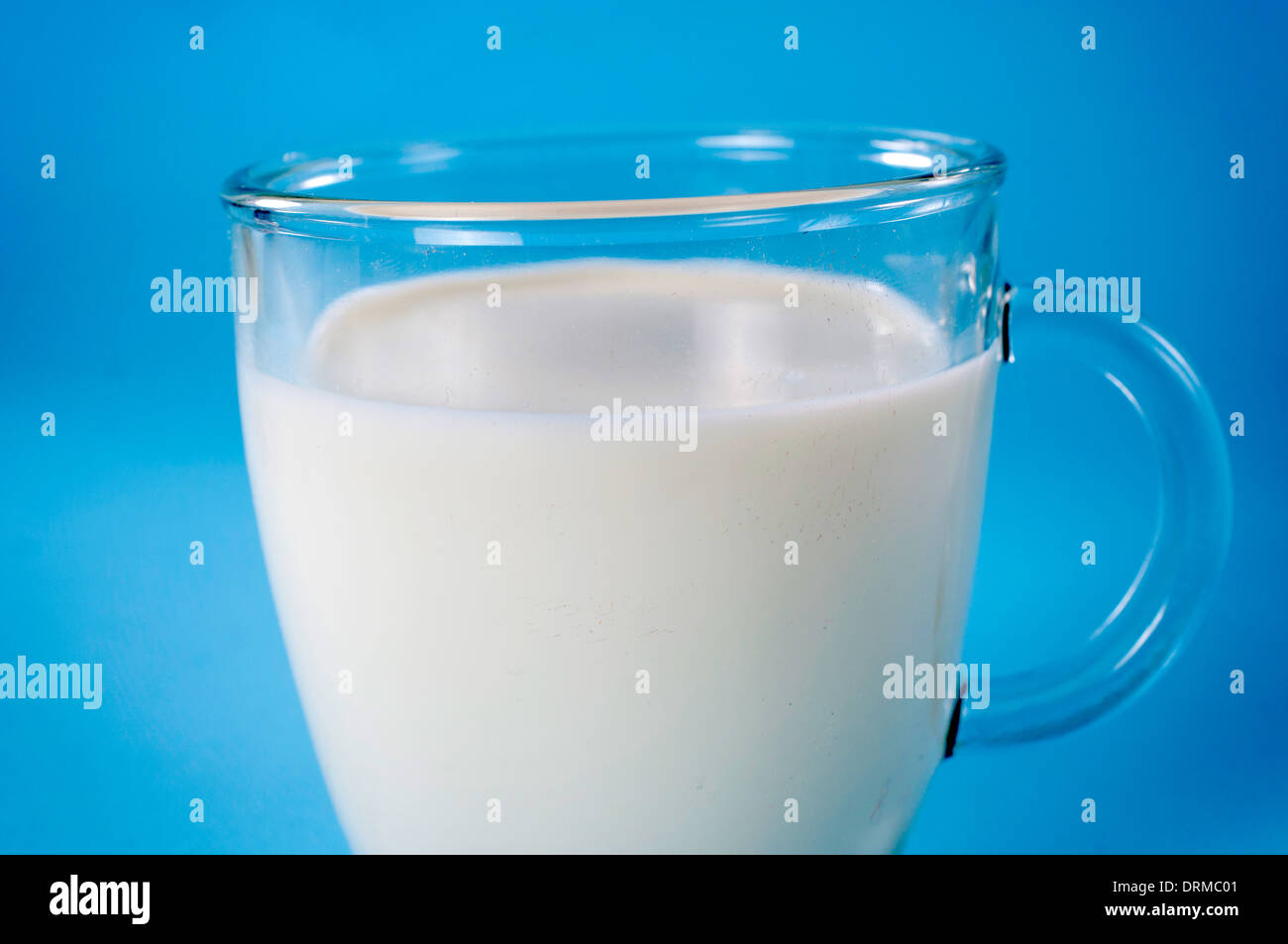 Glass of milk on the light blue background Stock Photo - Alamy