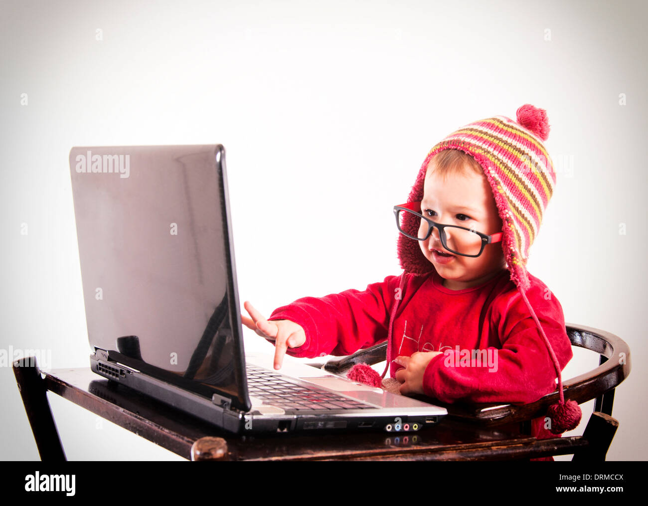 Selective focus on the little baby on laptop computer Stock Photo - Alamy