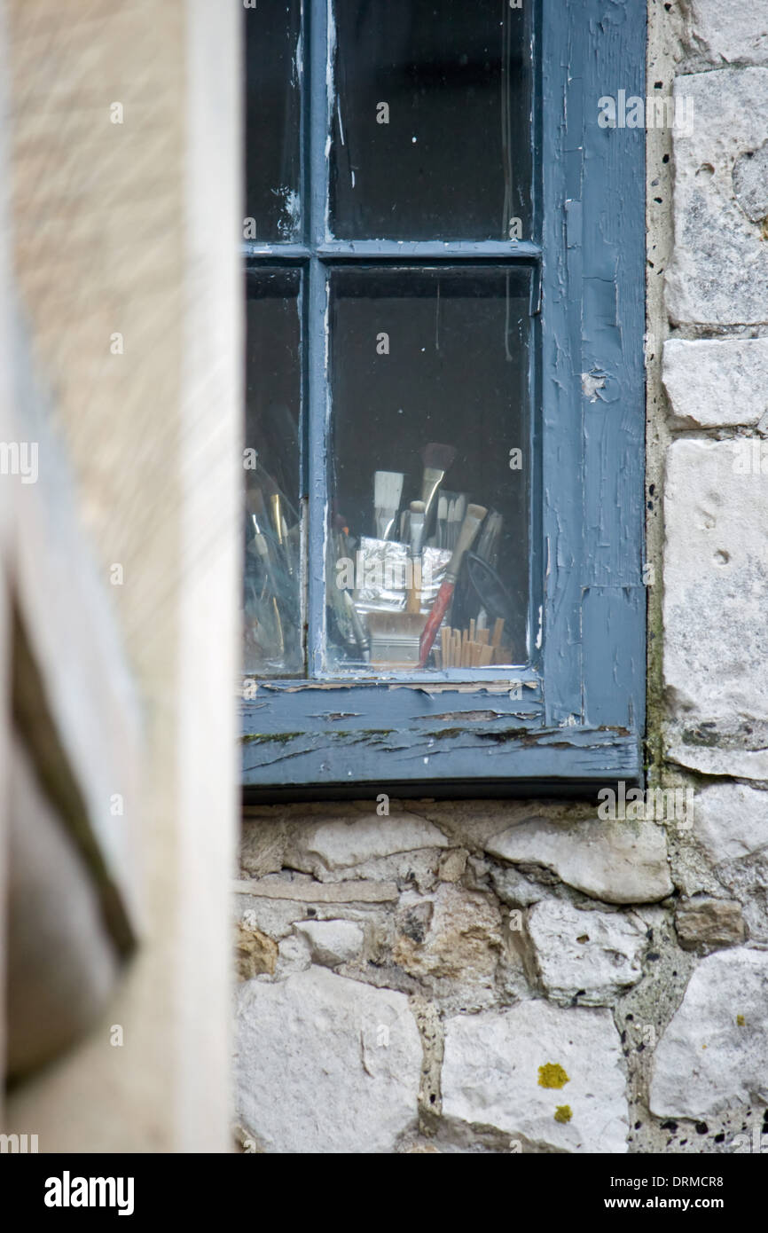 Paint brushes in the window of a artists' studio Stock Photo - Alamy