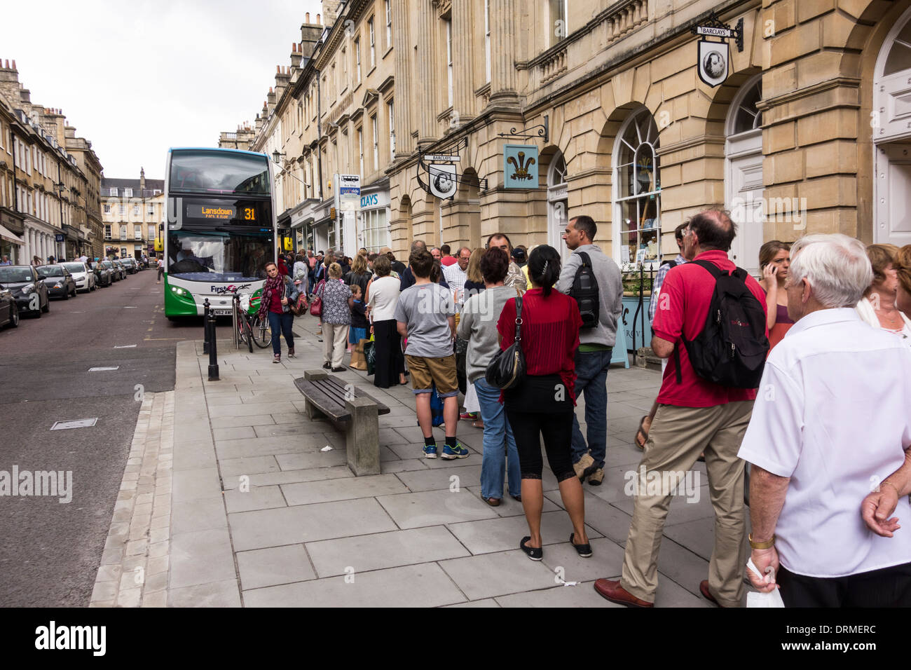 People in a queue for a bus, Bath, Somerset, UK Stock Photo - Alamy