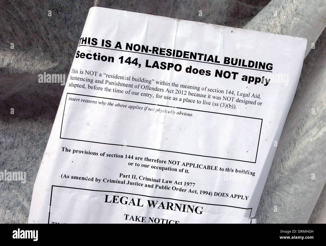 Legal notice in window of squat in non-residential building, London ...