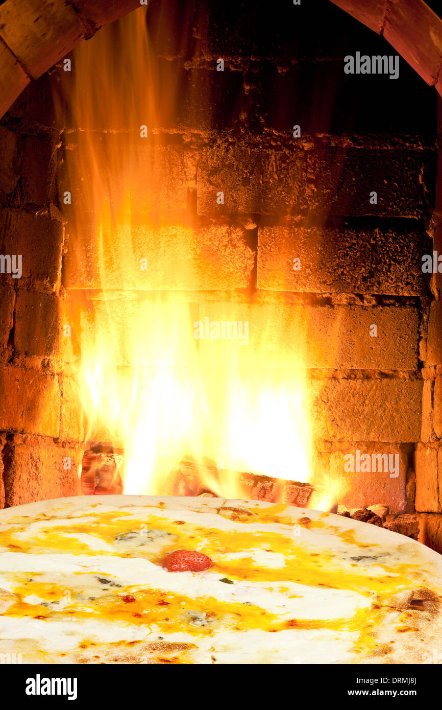 italian pizza and fire flames in wood burning oven Stock Photo - Alamy