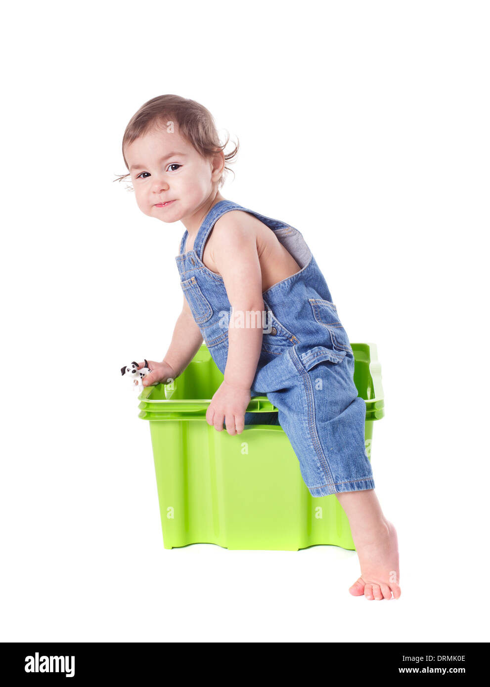 Kid plays with container Stock Photo - Alamy