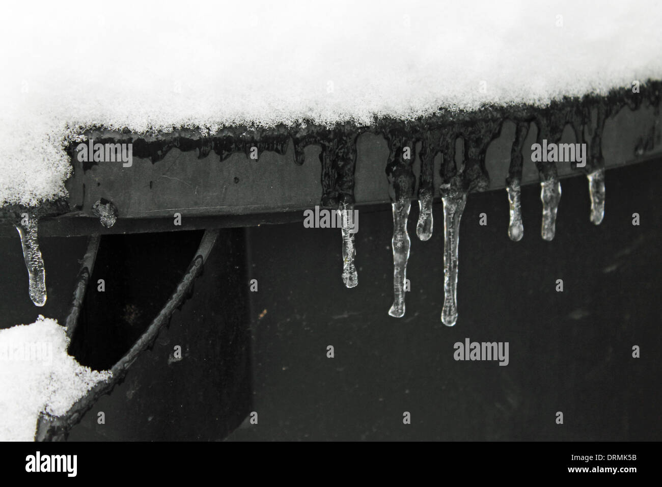 Icicles hanging from a snow-covered trash can Stock Photo - Alamy